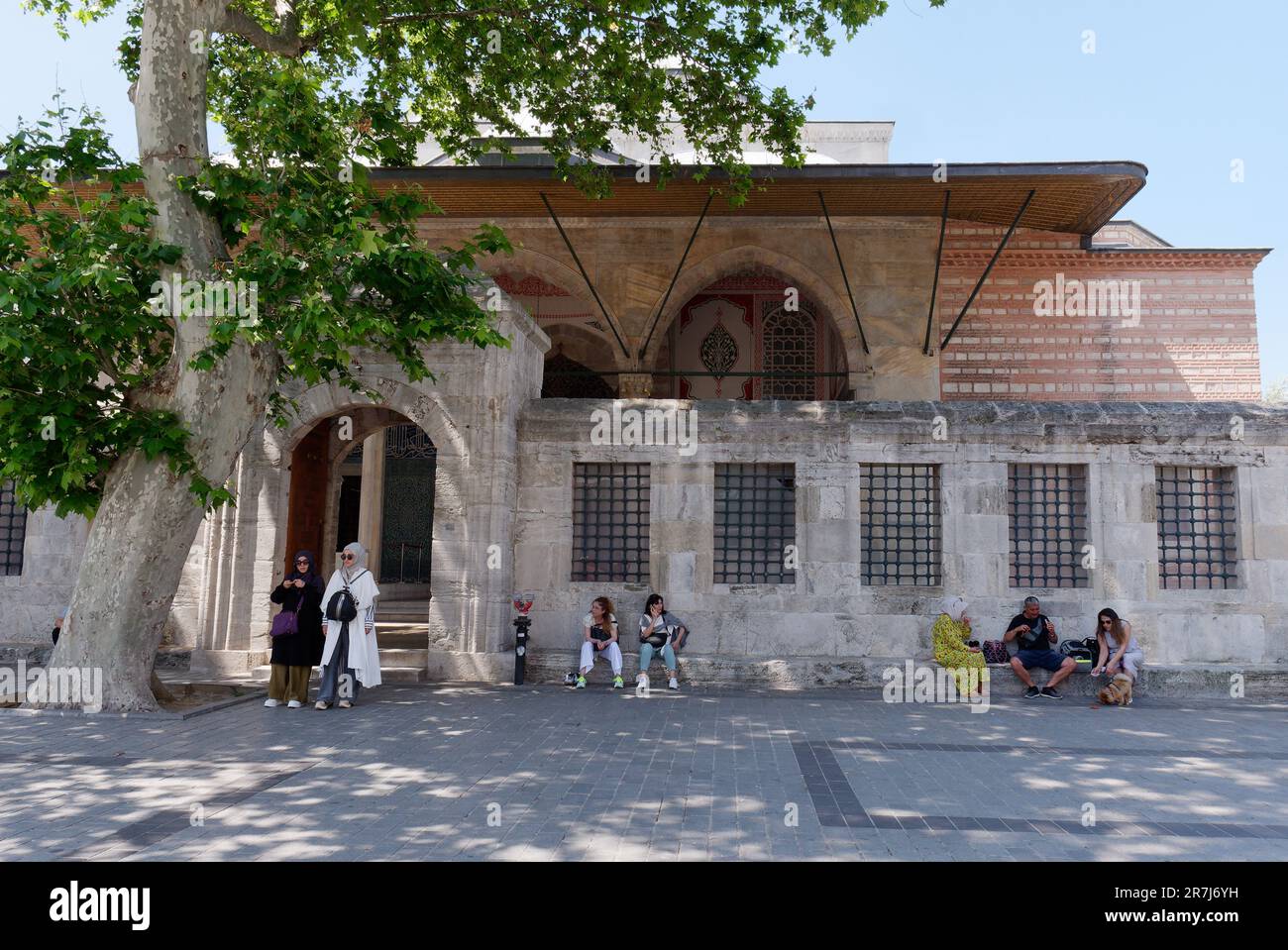 People sitting in the shade at the entrance to Hatice Turhan Valide ...