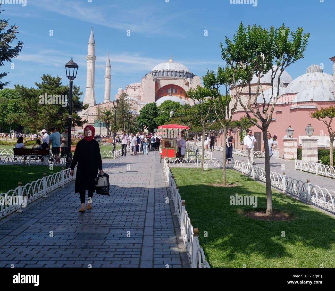 Muslim lady in head scarf walks in front of the Hagia Sophia Mosque ...