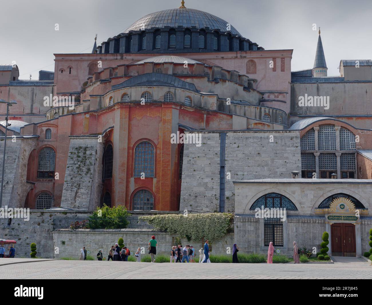 Side angle of the Hagia Sophia Mosque which towers above the tourists ...