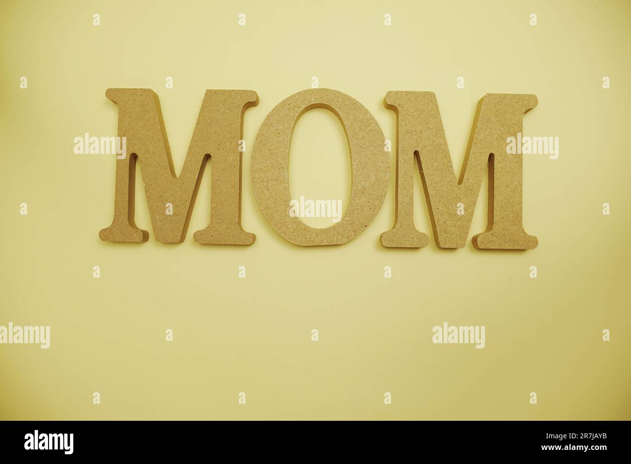 Mother's day theme with MOM letters on yellow background Stock Photo ...