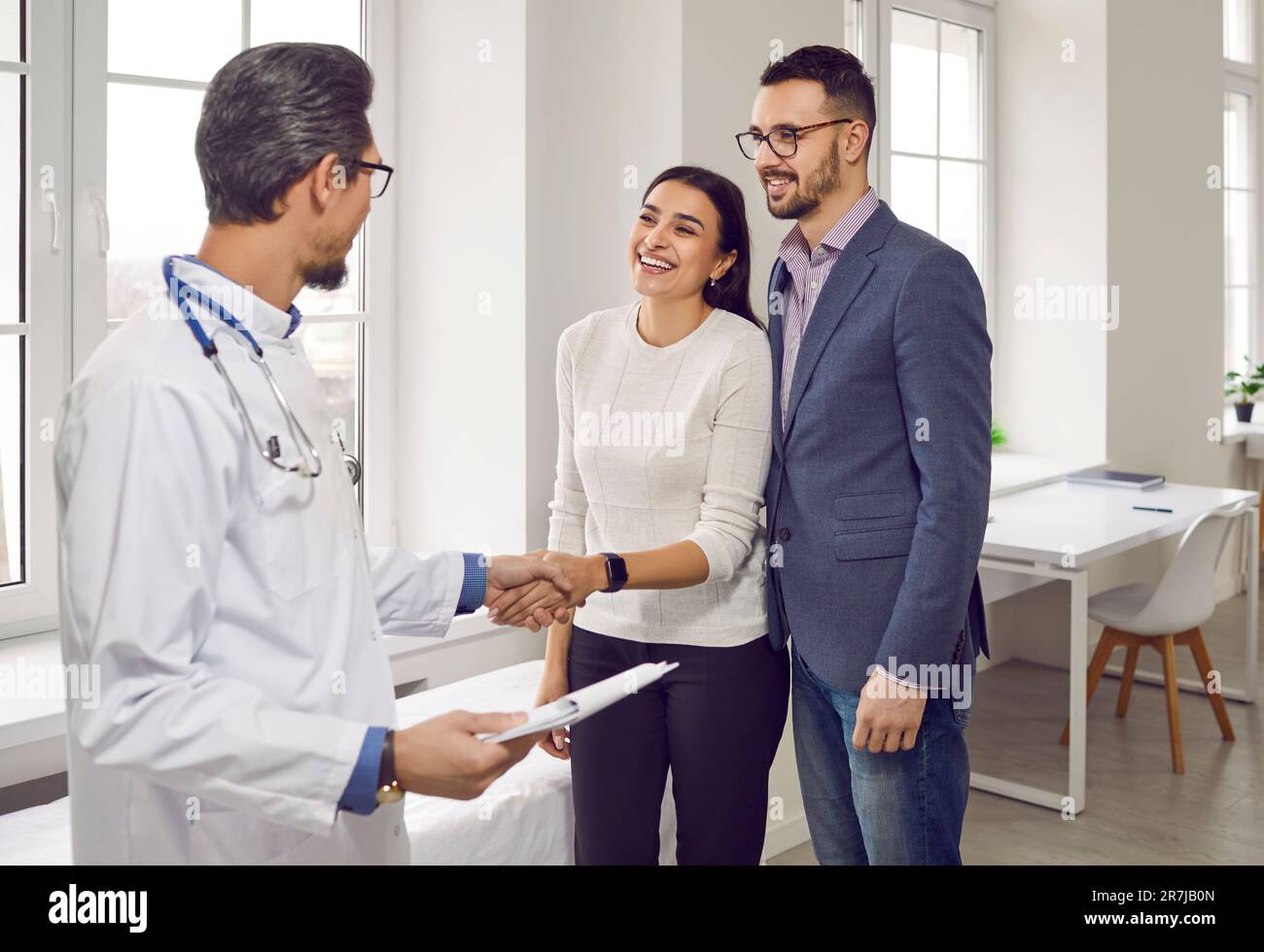 Young beautiful couple at doctor's appointment in the office of the ...