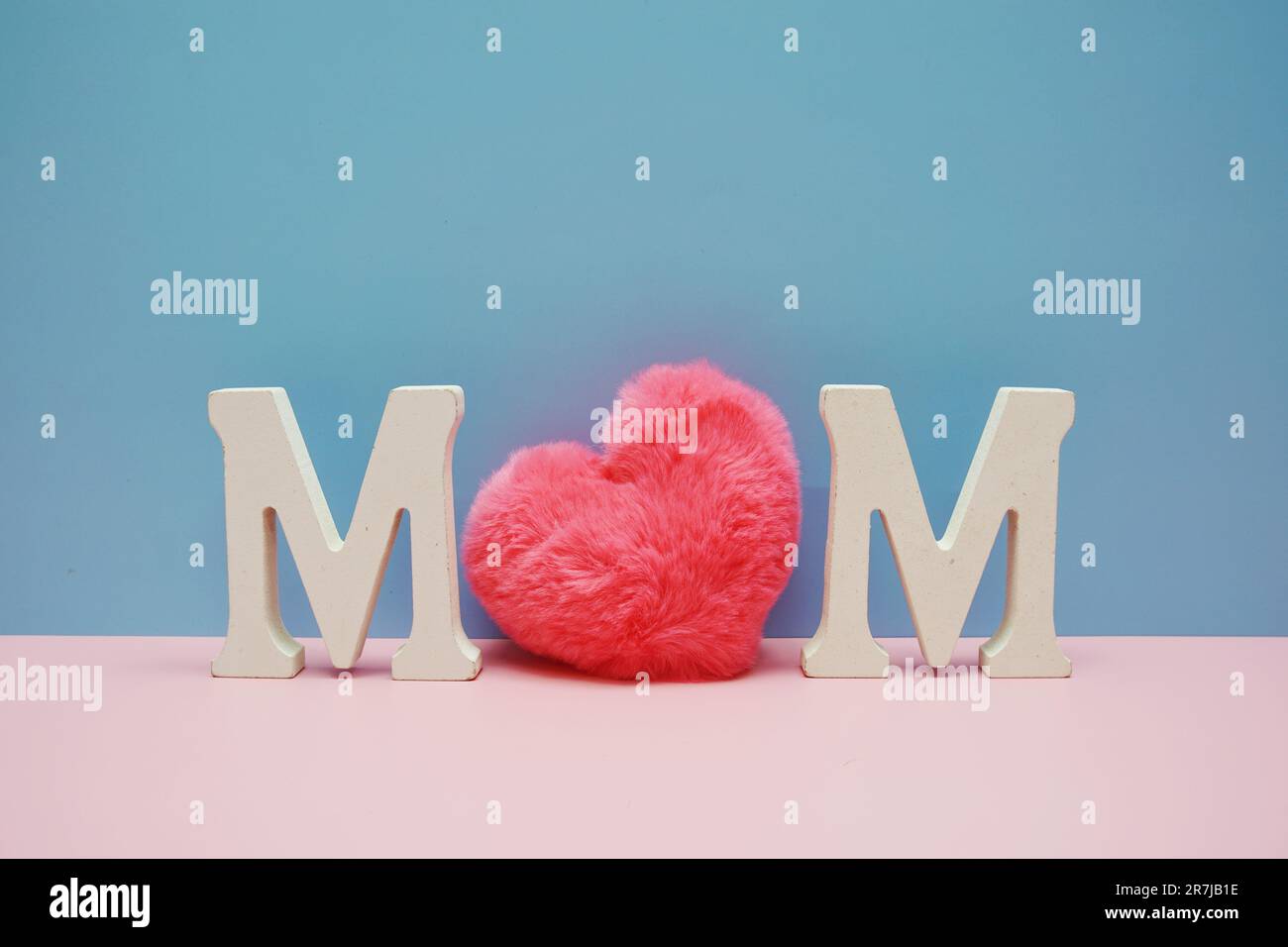 Mother's day background with MOM letters and heart on pink background ...