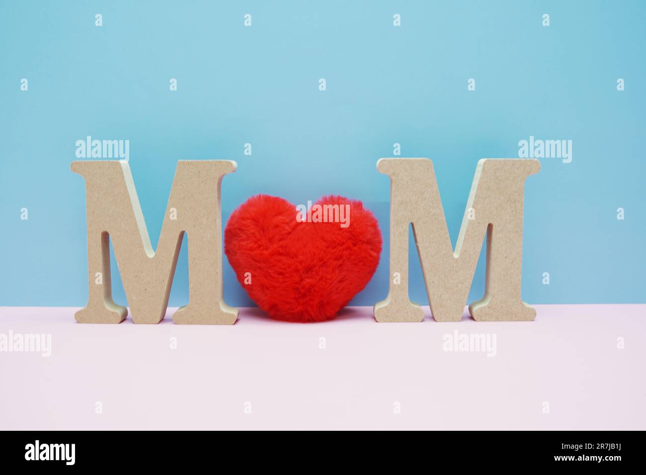 Mother's day background with MOM letters and heart on pink background ...