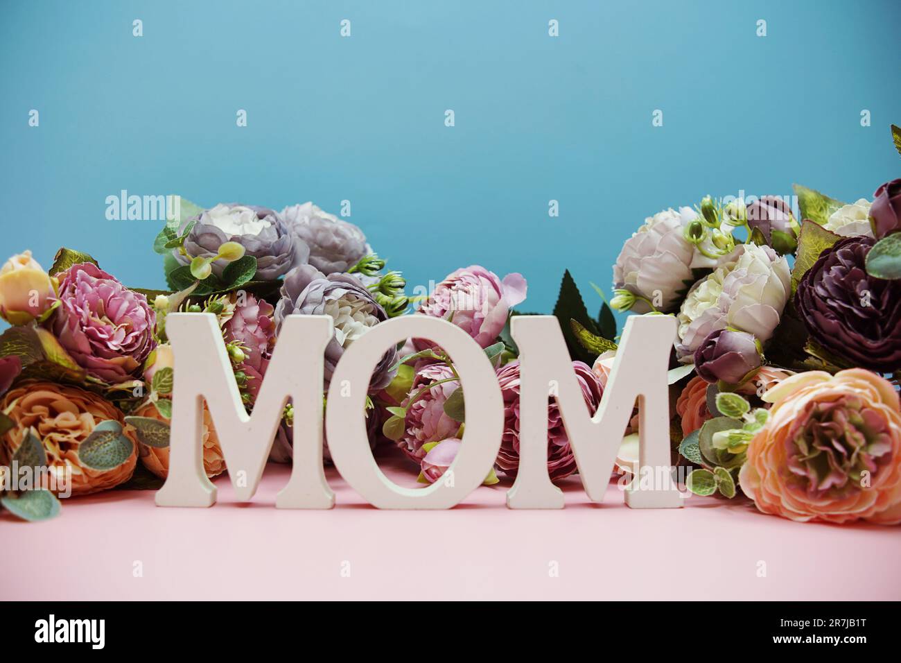 Mother's day theme with MOM letters and flowers decoration on pink and ...