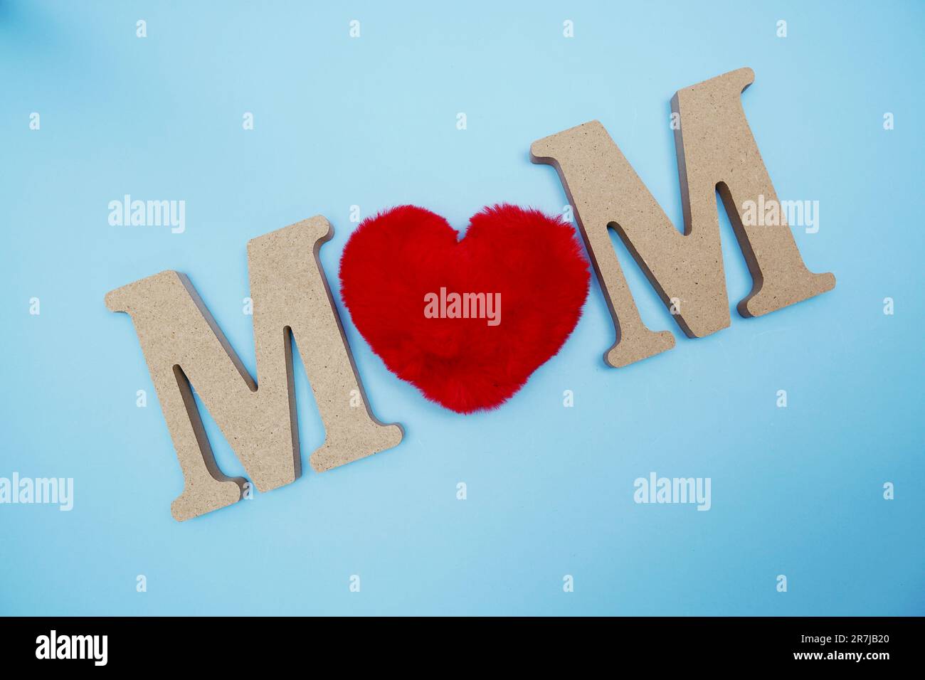 Mom alphabet letter and red heart flat lay on blue background Stock ...