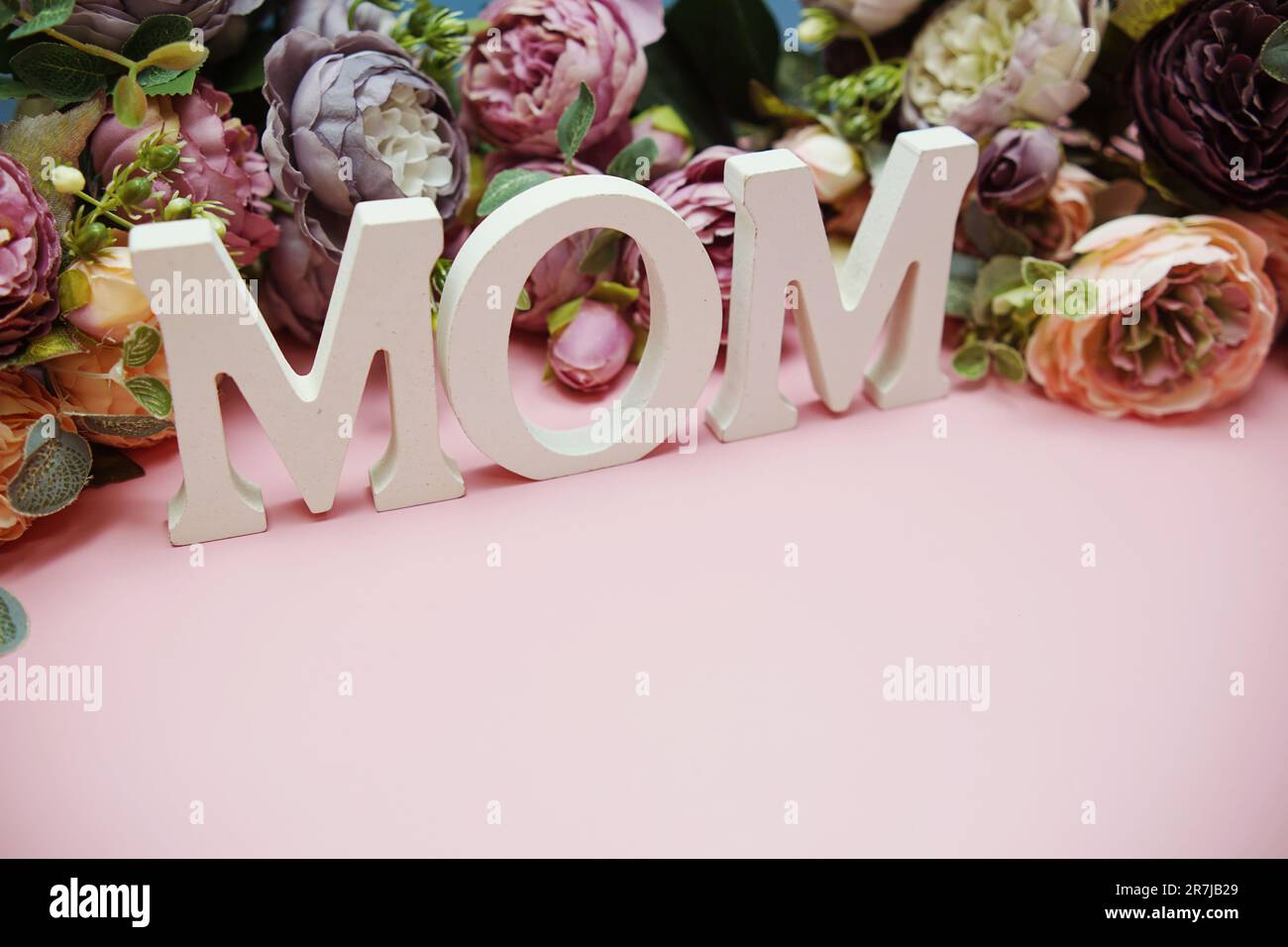 Mother's day theme with MOM letters and flowers decoration on pink and ...