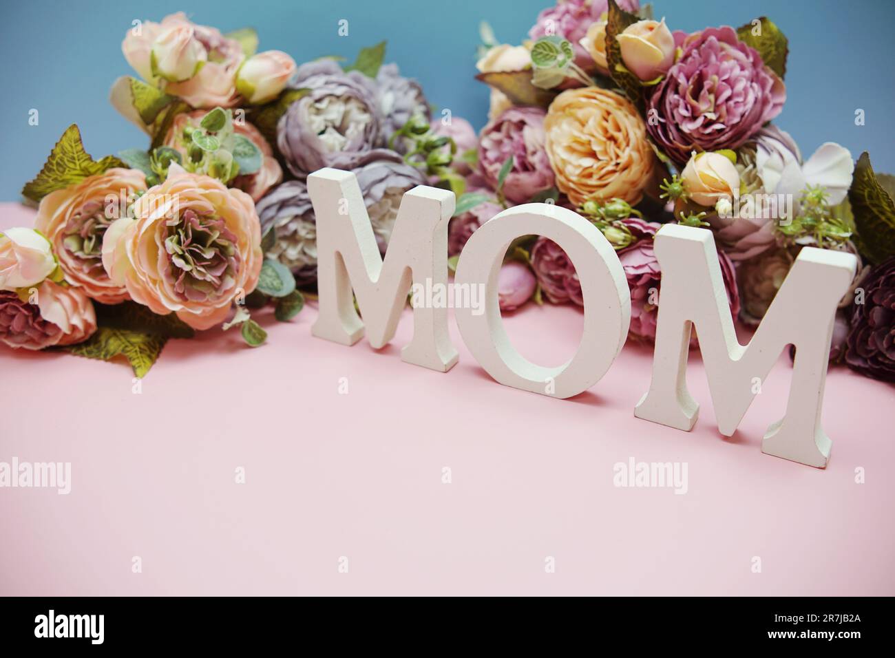 Mother's day theme with MOM letters and flowers decoration on pink and ...