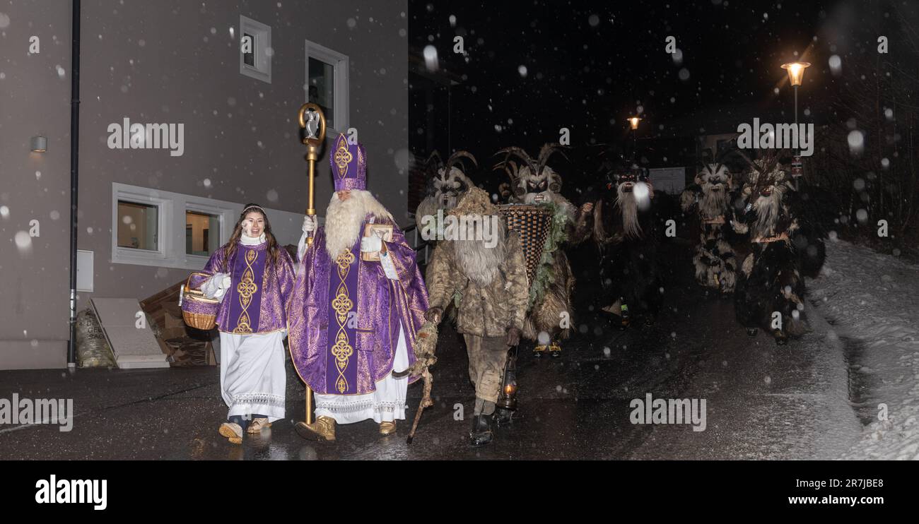 Procession of St. Nicholas and the legendary Krampus along a deserted ...