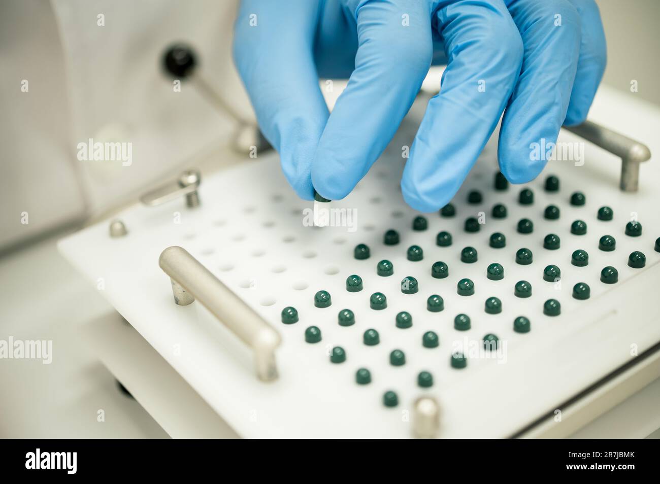 Crop compounding pharmacist putting pill into capsule filler Stock ...