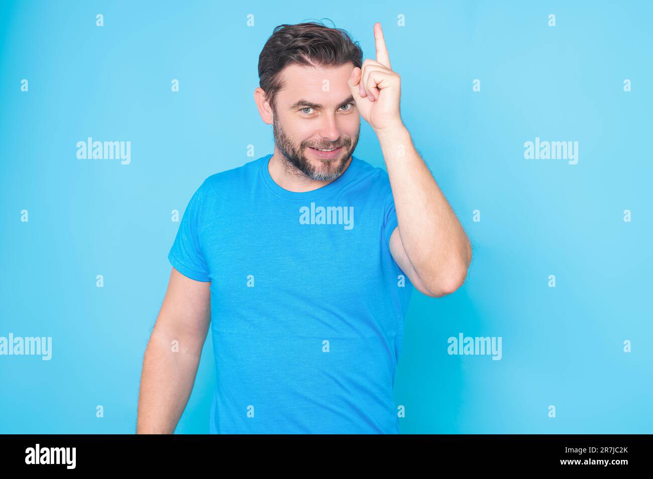 Thoughtful man point up thinking of idea, pointing up. Portrait of man ...