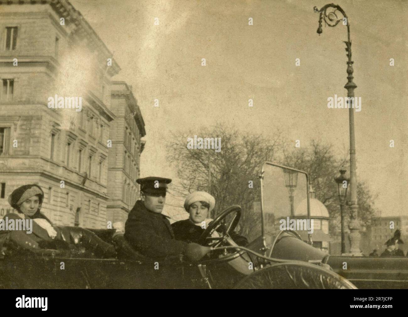 Two women and a driver in an open car, Italy 1920s Stock Photo - Alamy