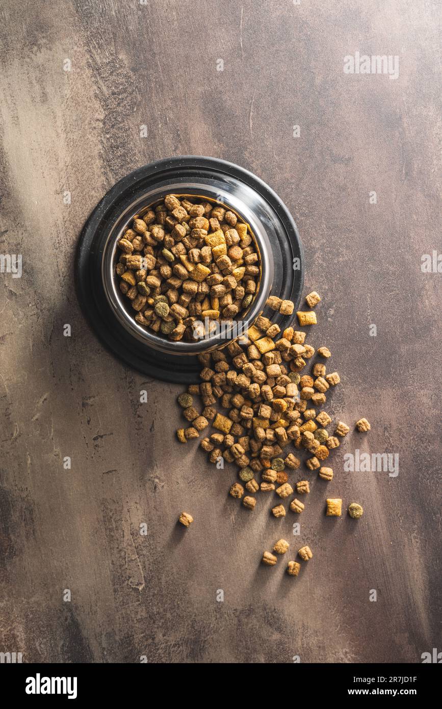 Dry kibble pet food. Dog or cat food on the old table. Top view Stock ...