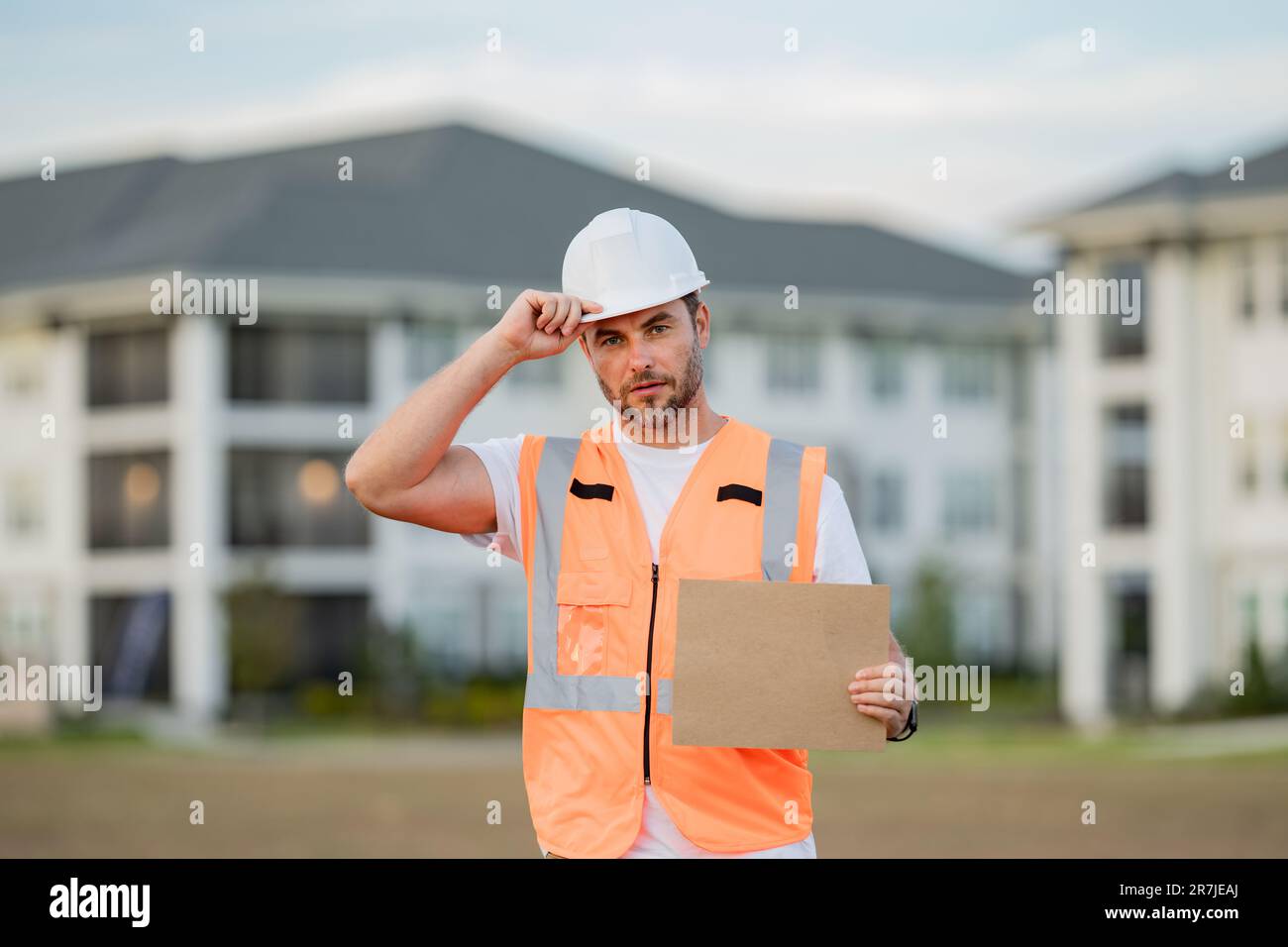 Engineer hold paper board for text. Builder showing signboard placard ...
