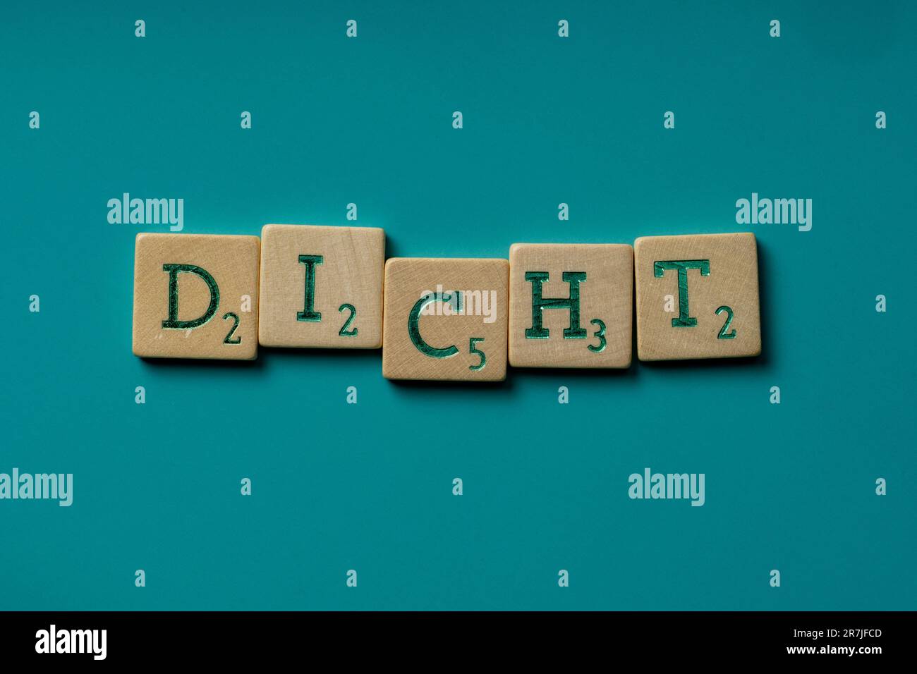 The wooden letters spelling the word dicht (dutch for closed) on a blue ...