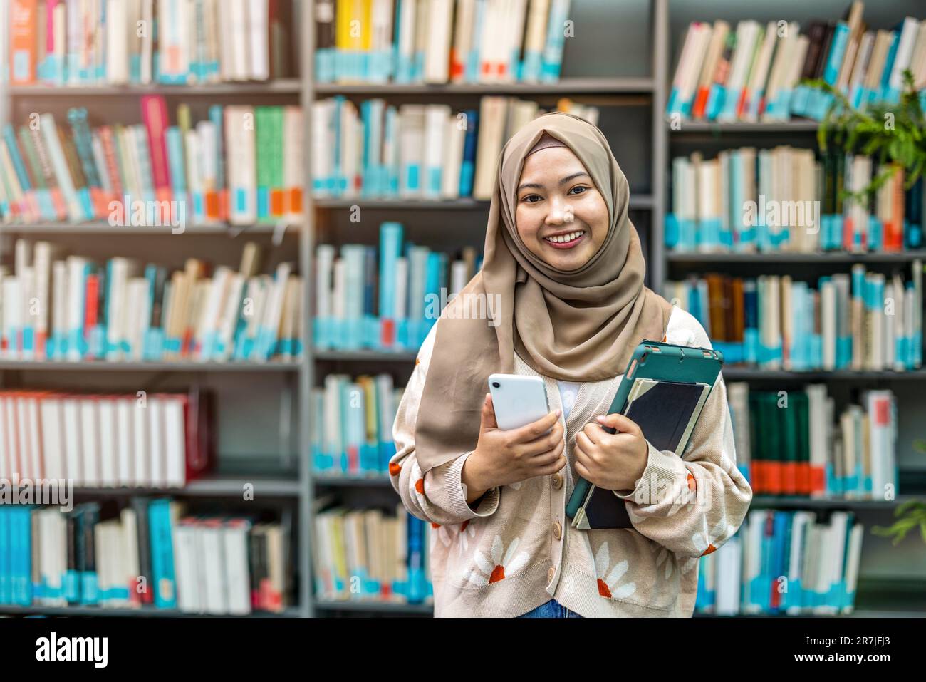 Portrait of asian muslim female student in a library Stock Photo - Alamy