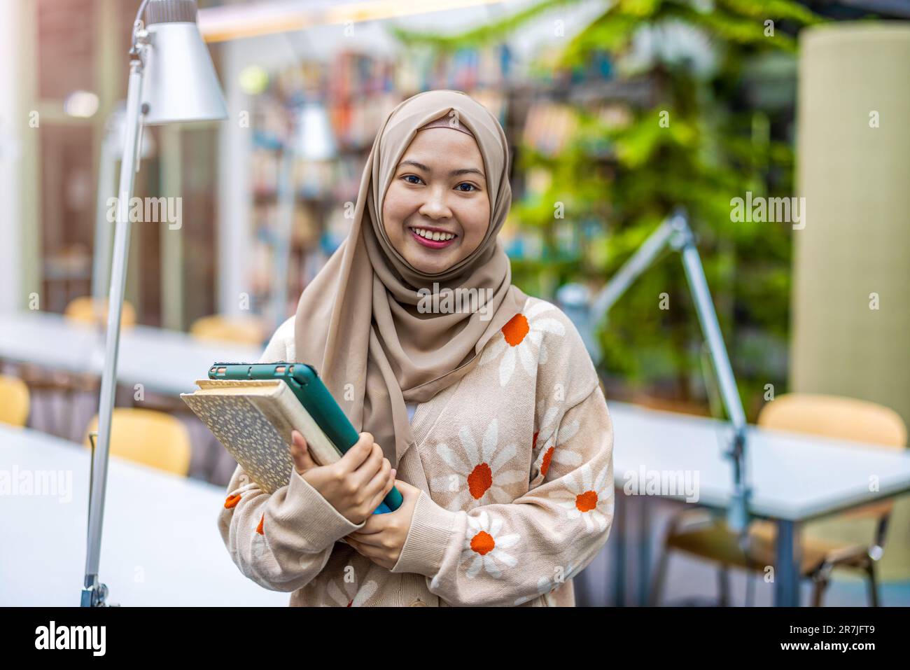 Portrait of asian muslim female student in a library Stock Photo - Alamy