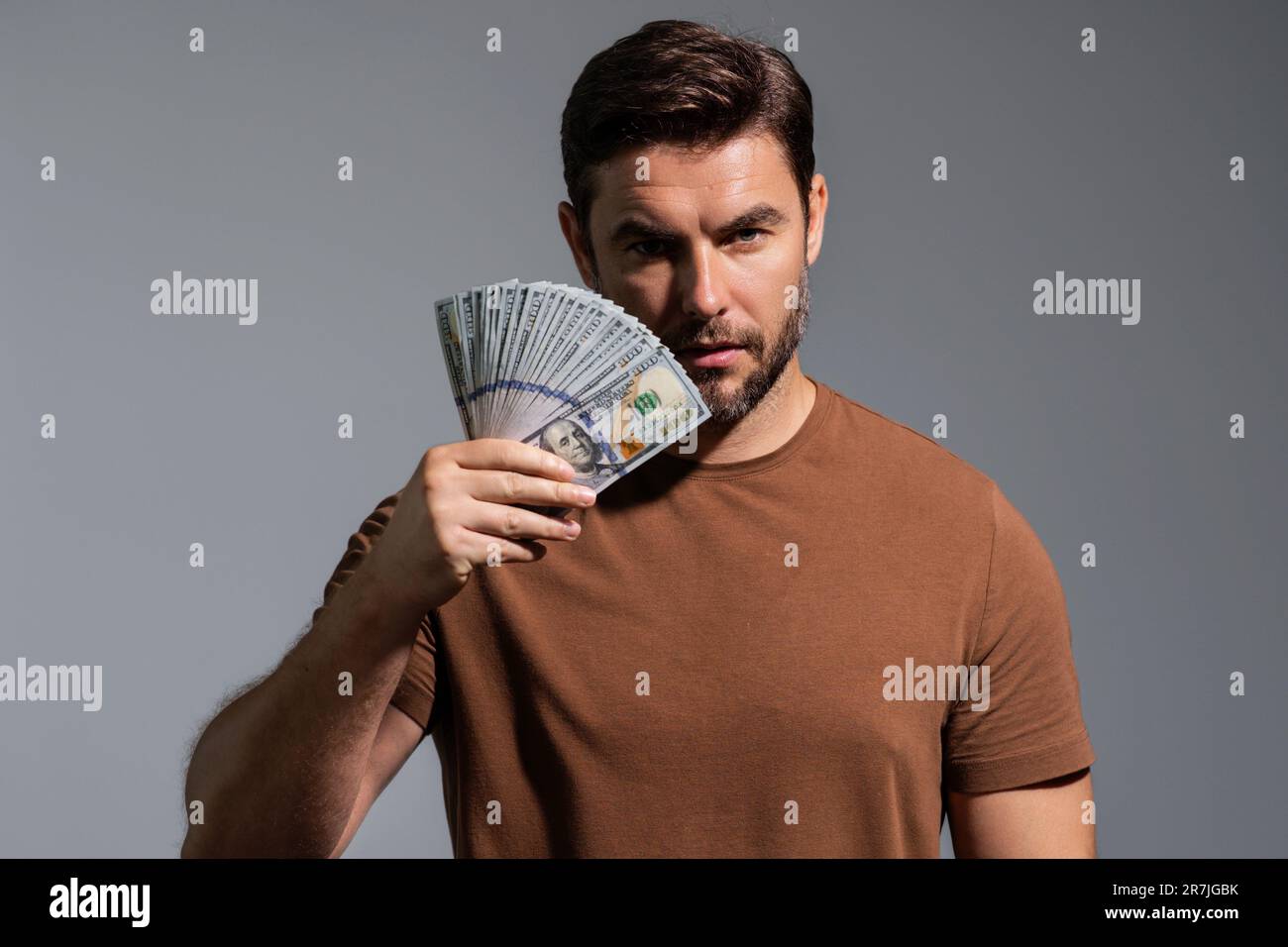Man showing cash money in dollar banknotes. Portrait of business man ...