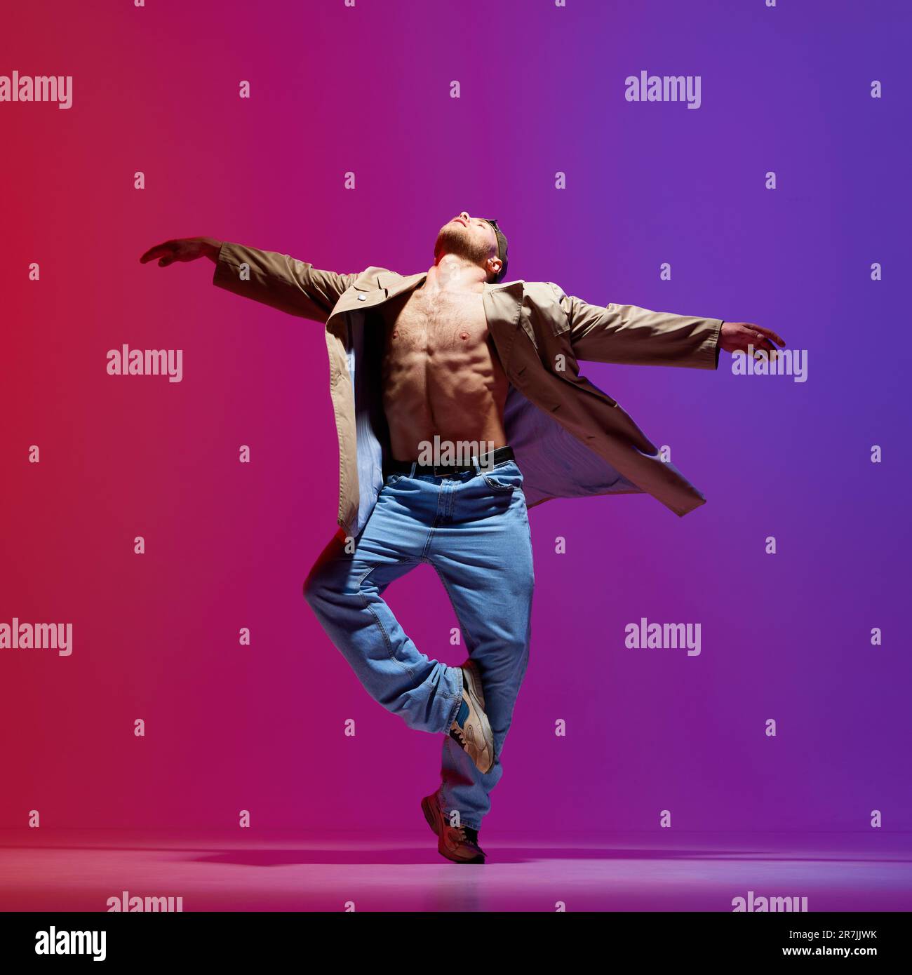 Young sportive man, in stylish casual clothes dancing breakdance, hip ...