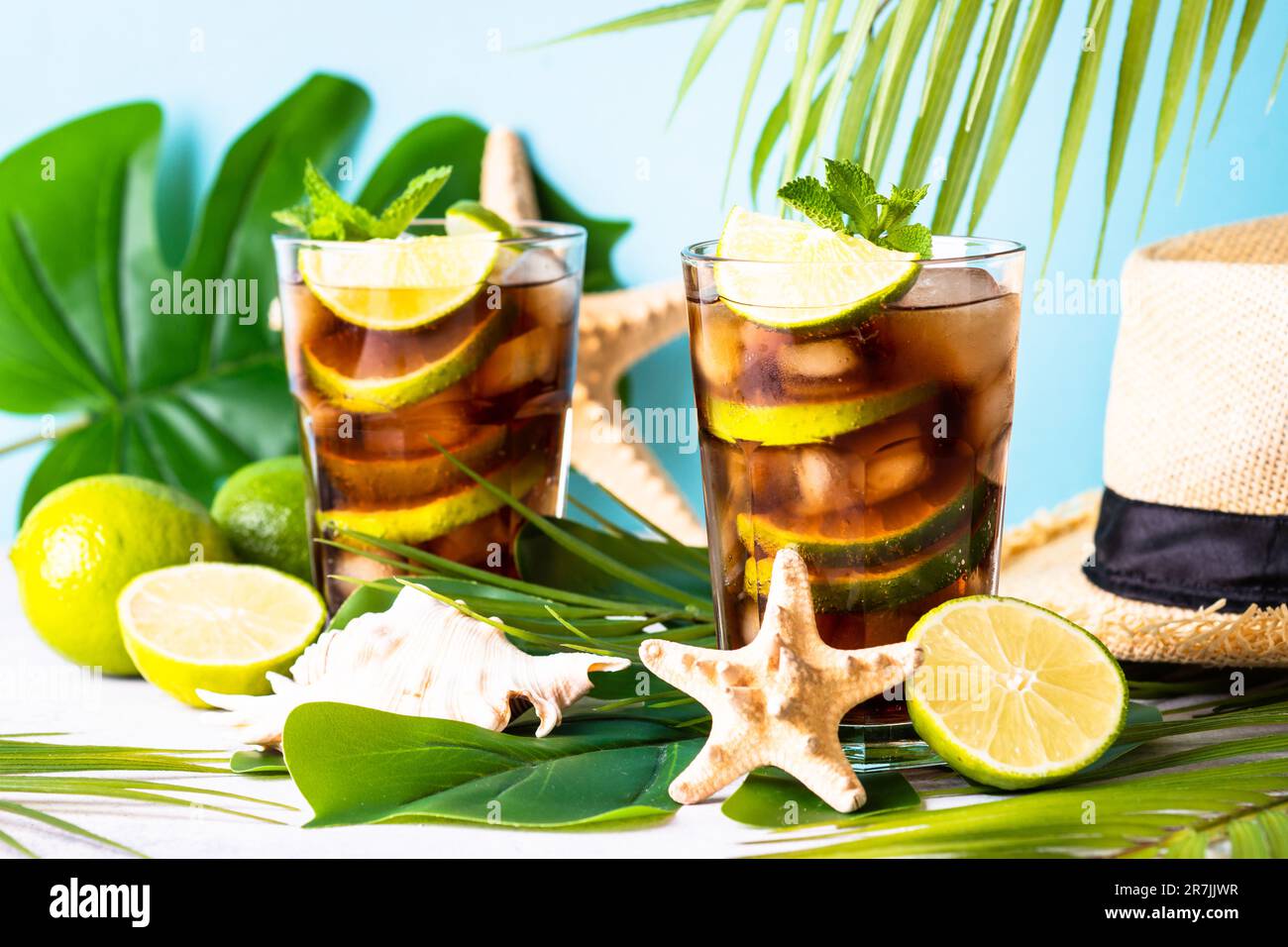 Cuba Libre or iced tea with palm leaves and sea shells Stock Photo - Alamy