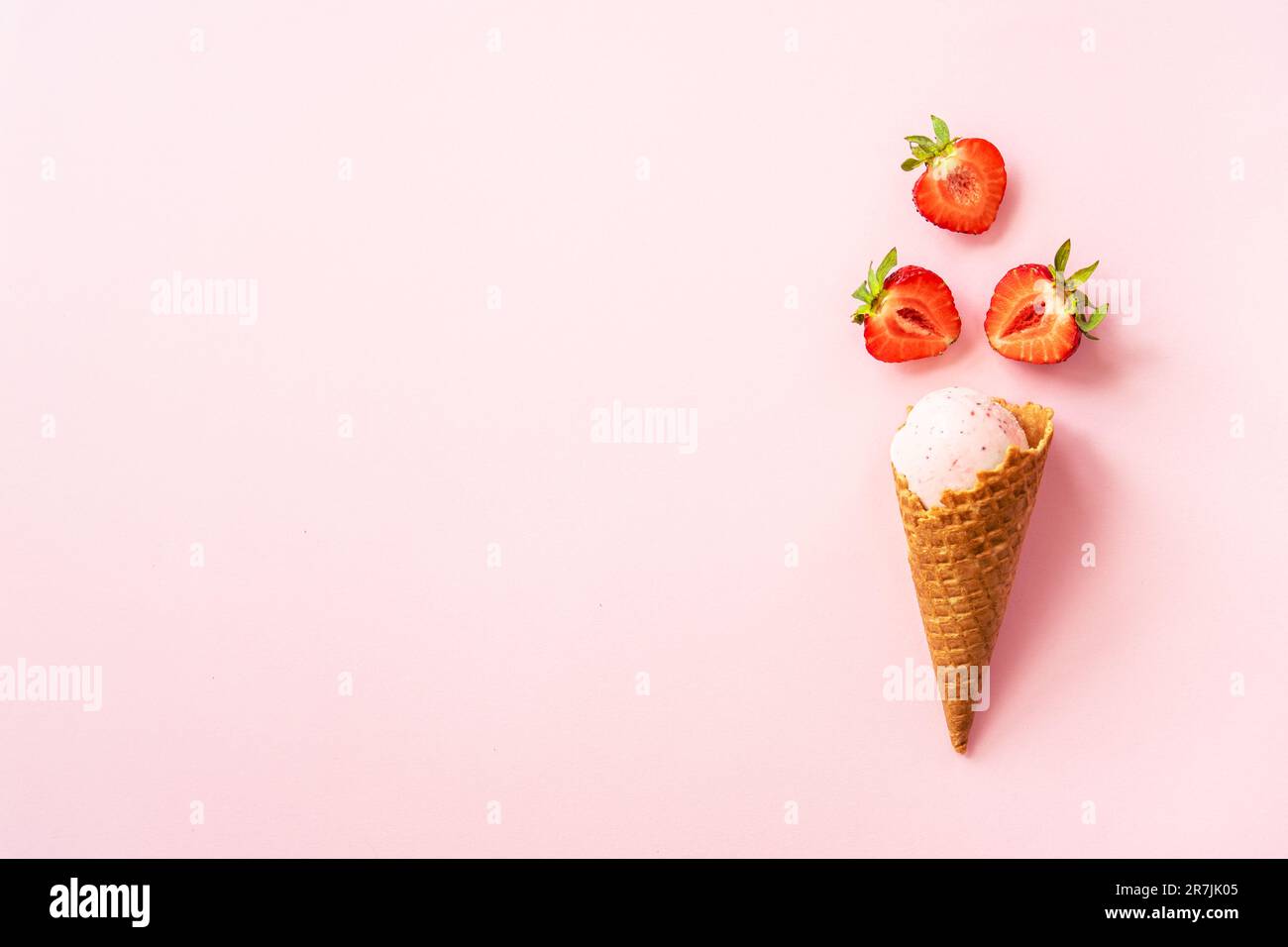 Strawberry ice cream cone top view on pink Stock Photo - Alamy
