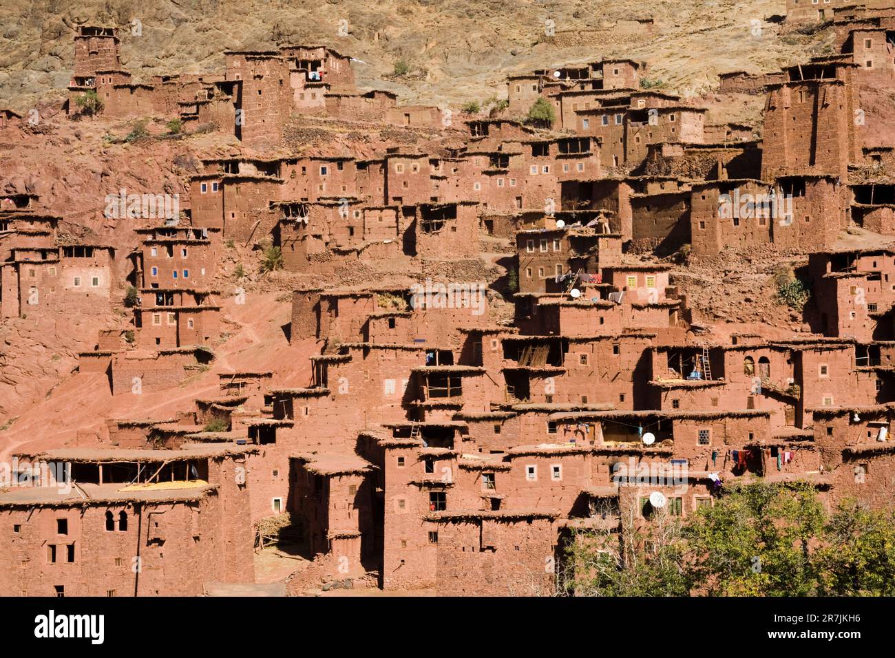 Stone and earth buildings built on a dramatic hillside in Magdaz, M ...