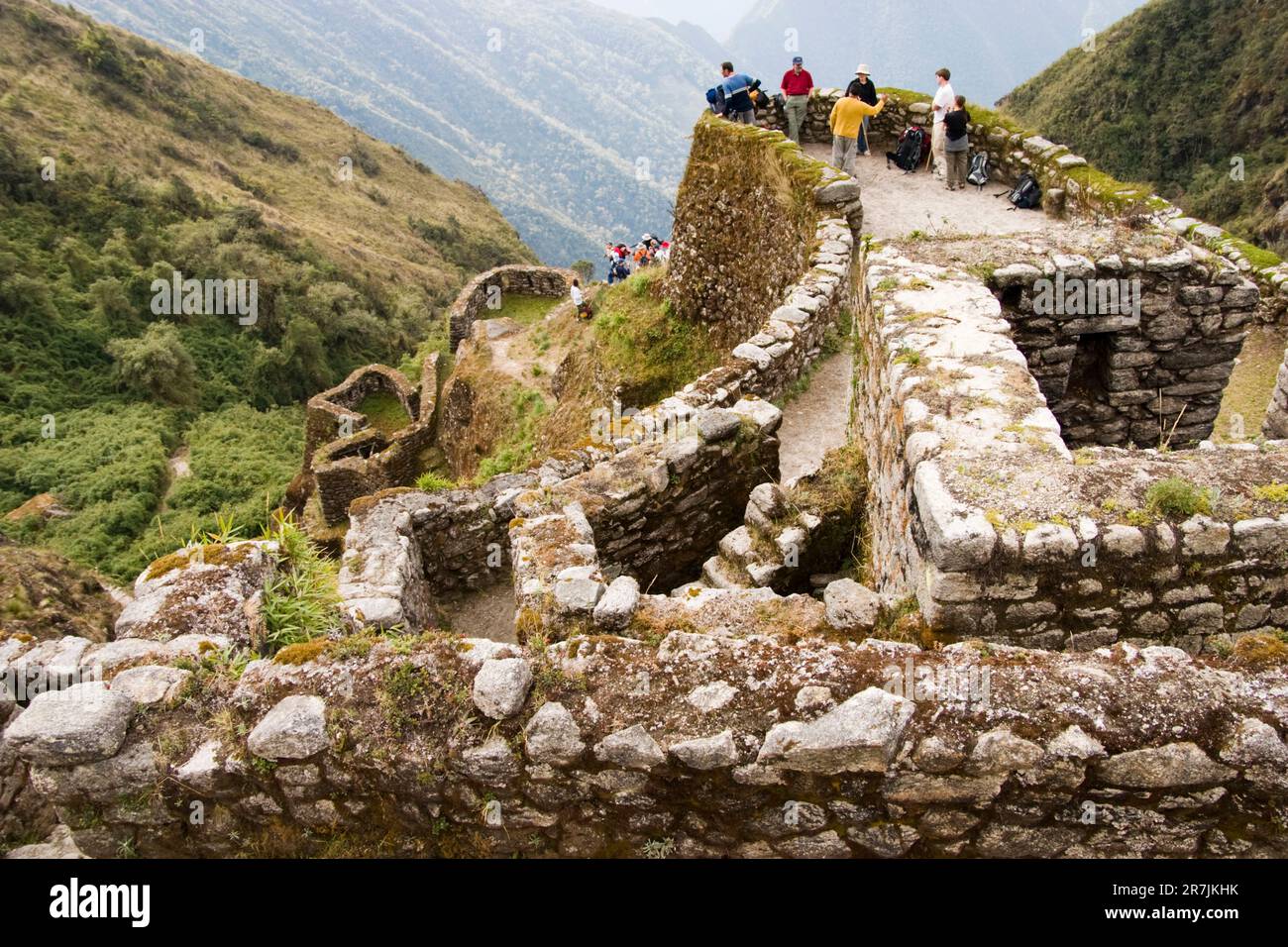 Groups of trekkers tour the Inca ruins of Phuyupatamarca along the Inca ...