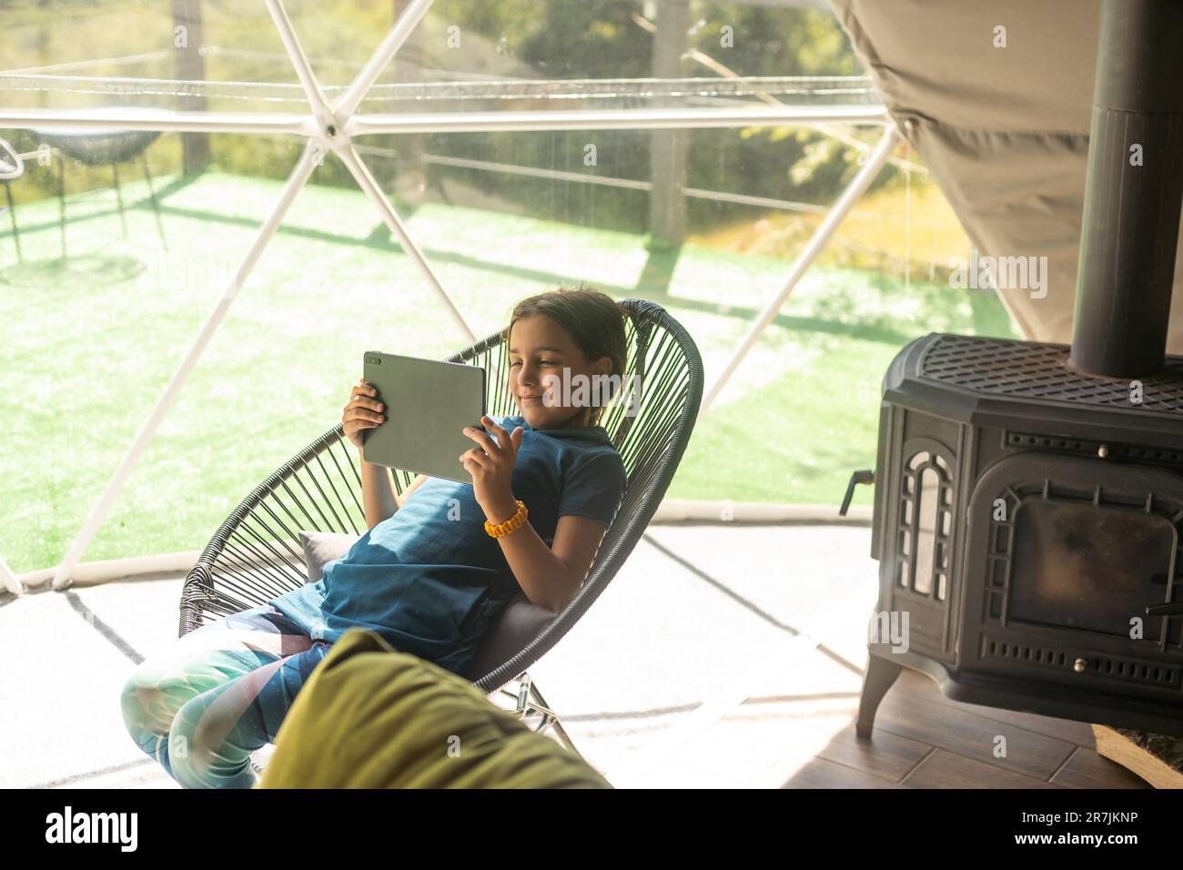childhood, technology and hygge concept - happy little girl with tablet ...