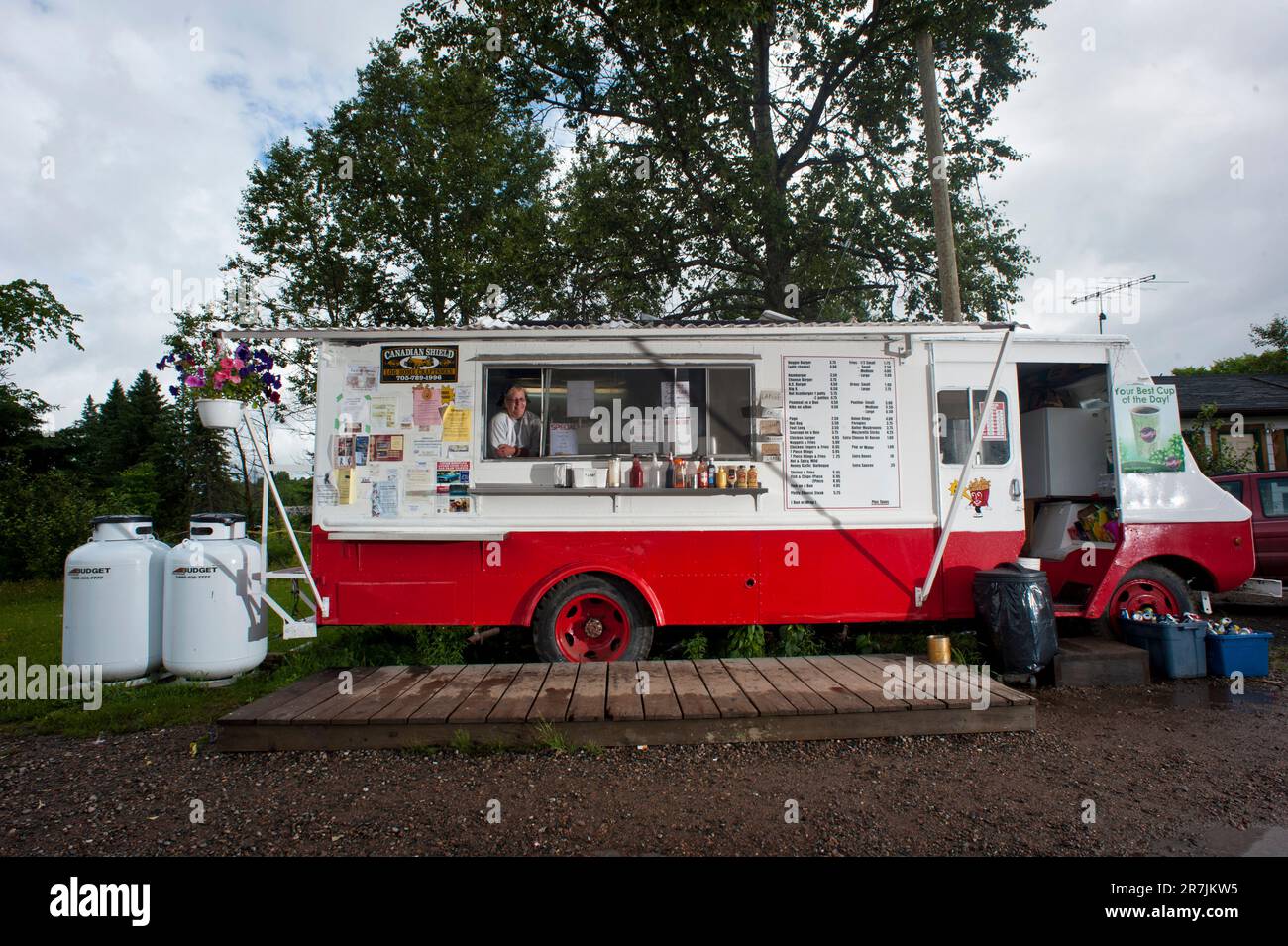 Chef and owner of the local fry truck stands proudly in the window of ...