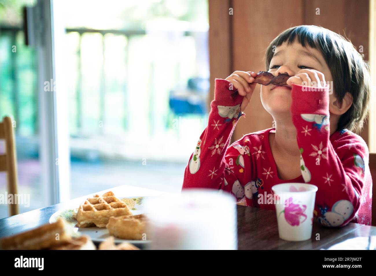 A young boy pretends a strip of bacon is his moustache Stock Photo - Alamy