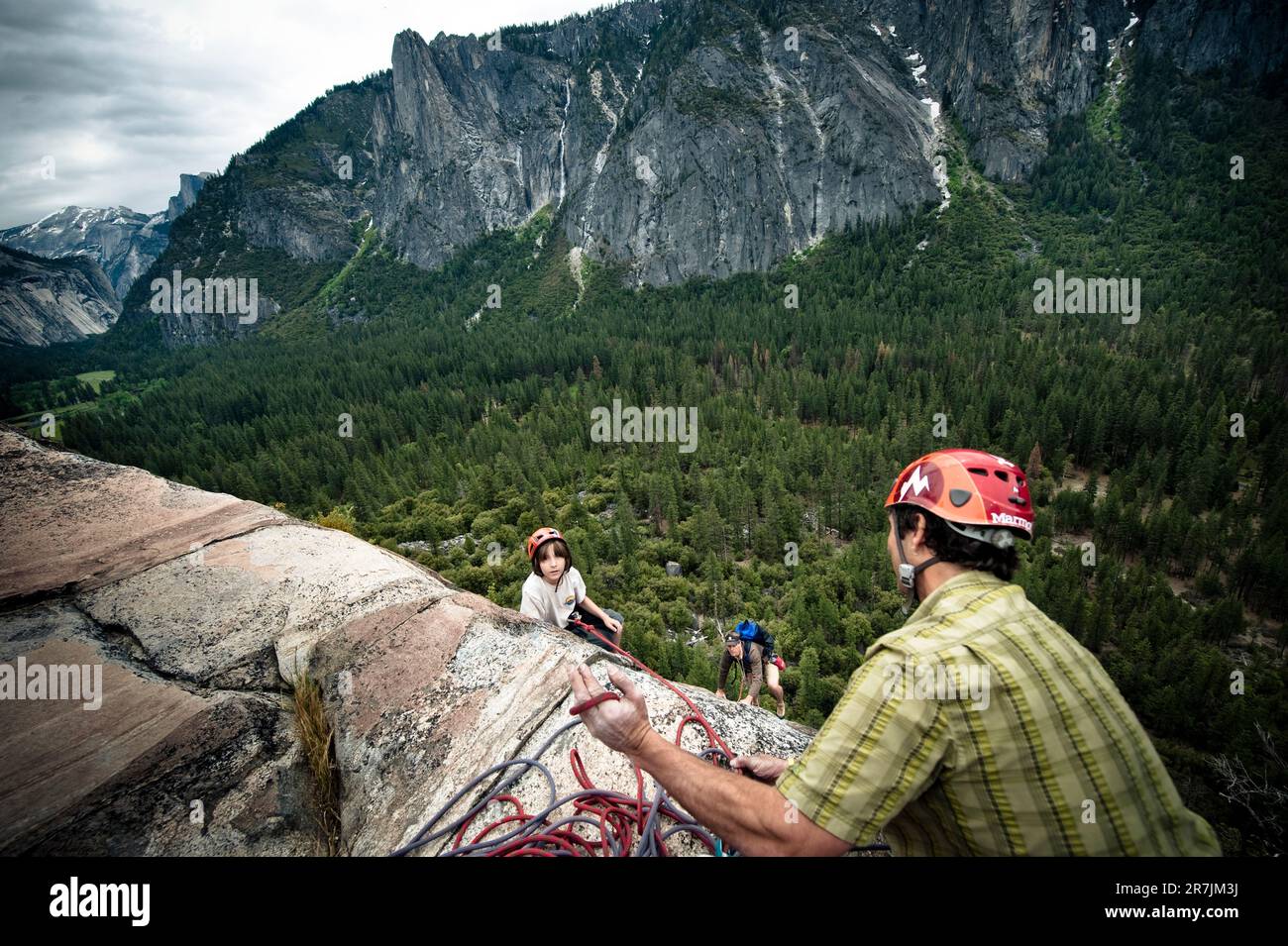Two climbers and a young boy at the top of a climb in Yosemite, June ...