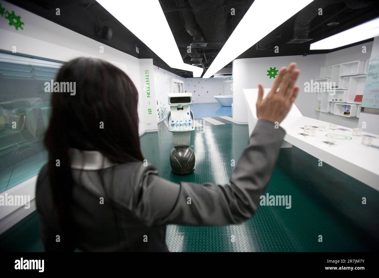 A woman commands a robot at Fusion world, a showcase for futuristic ...