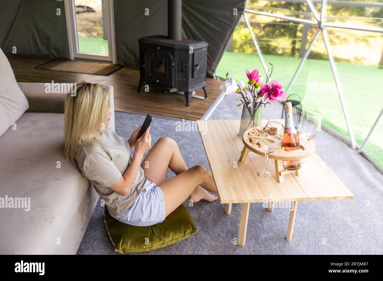 a woman enjoys solitude inside of a transparent bubble hotel Stock ...