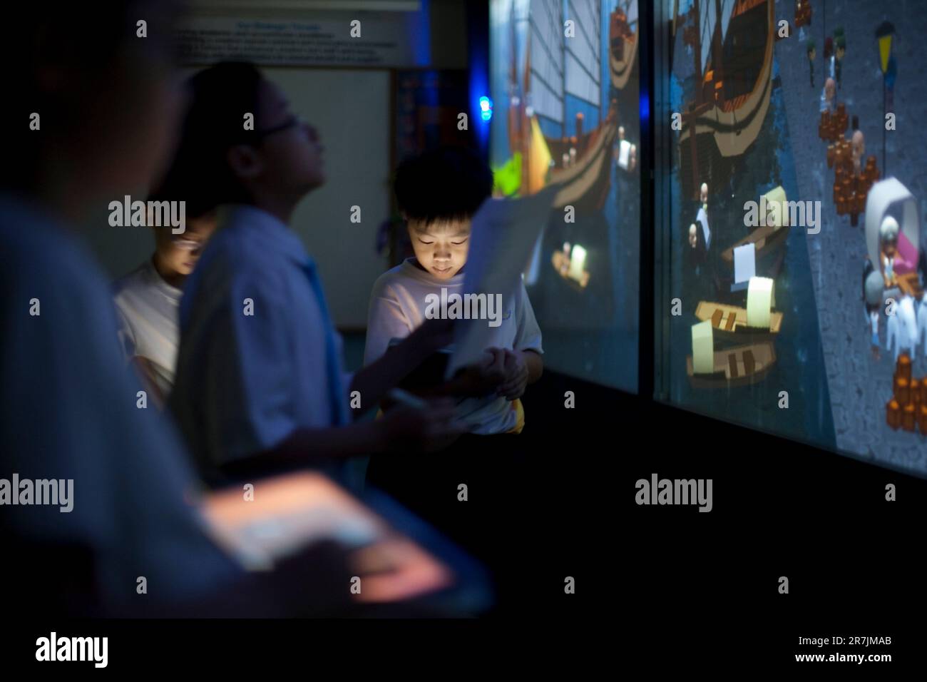 Schoolchildren in Singapore use 4D immersion technology in a computer ...
