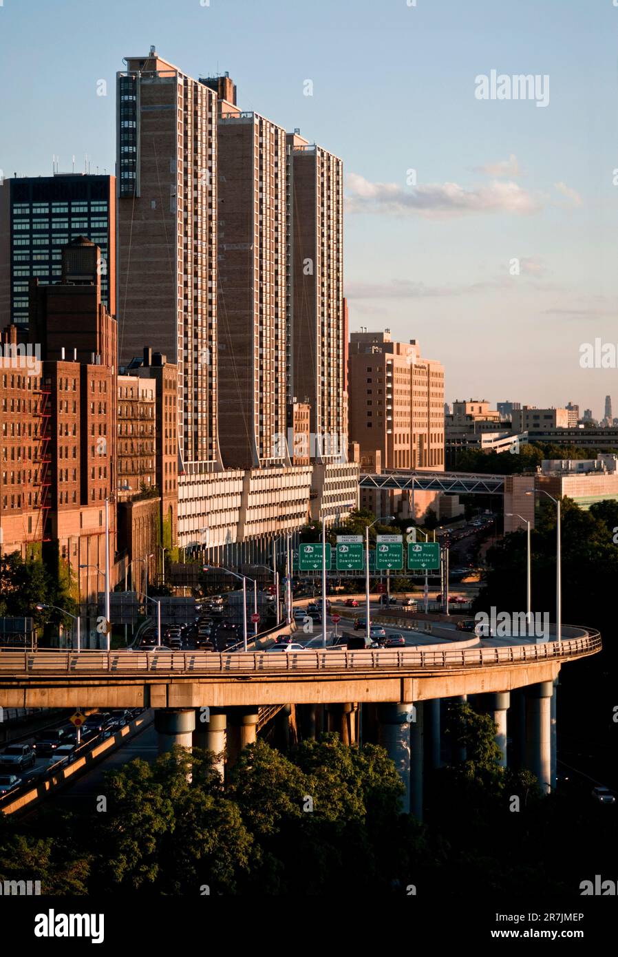 An elevated highway onramp extends in front of a row of tall buildings ...