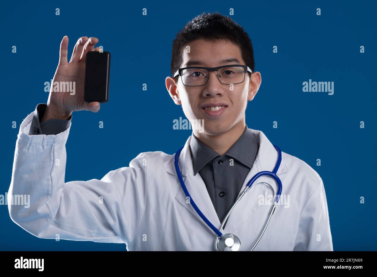 Asian medic showcases a digital device, endorsing telemedicine ...