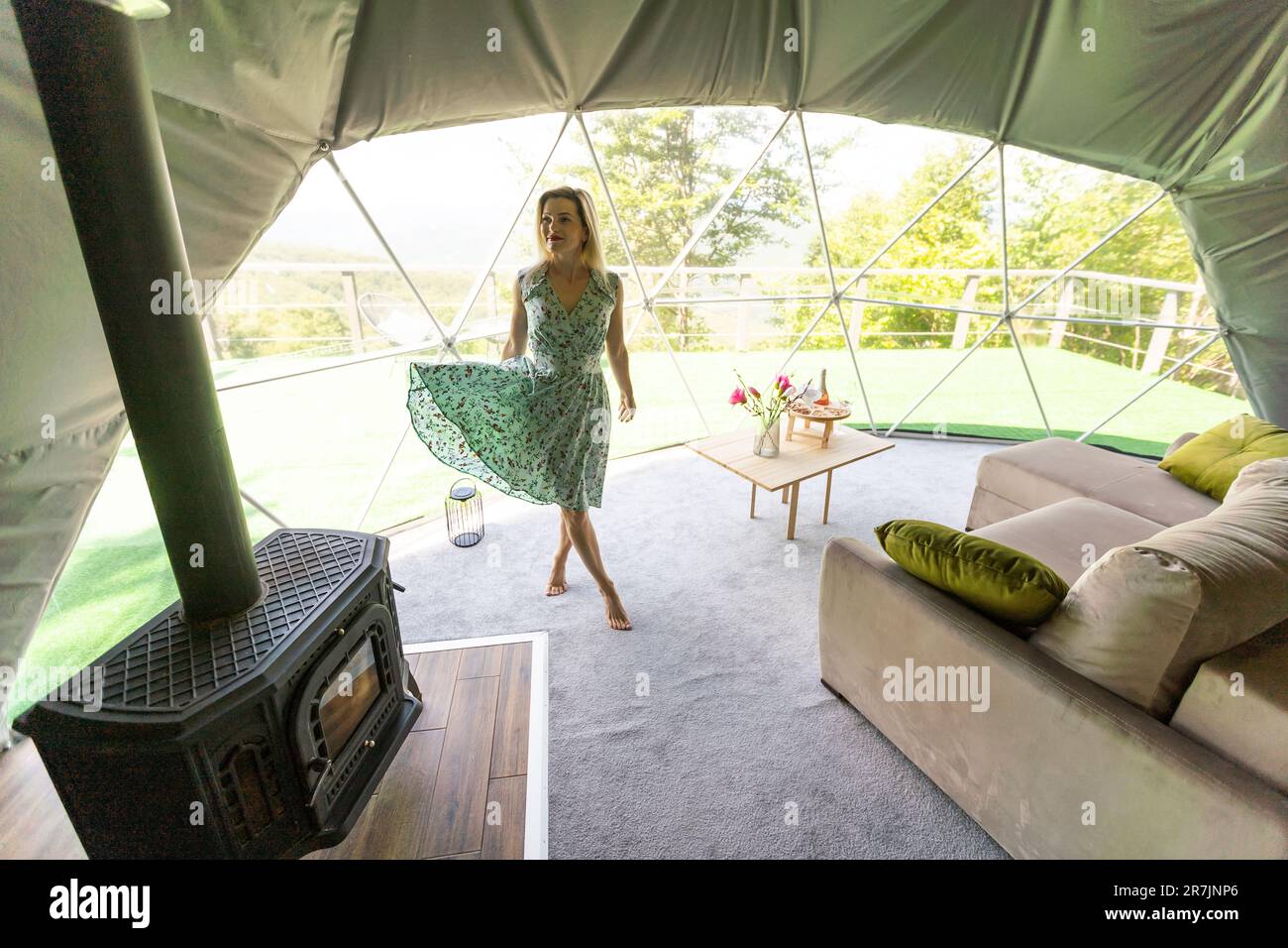 a woman enjoys solitude inside of a transparent bubble hotel Stock ...