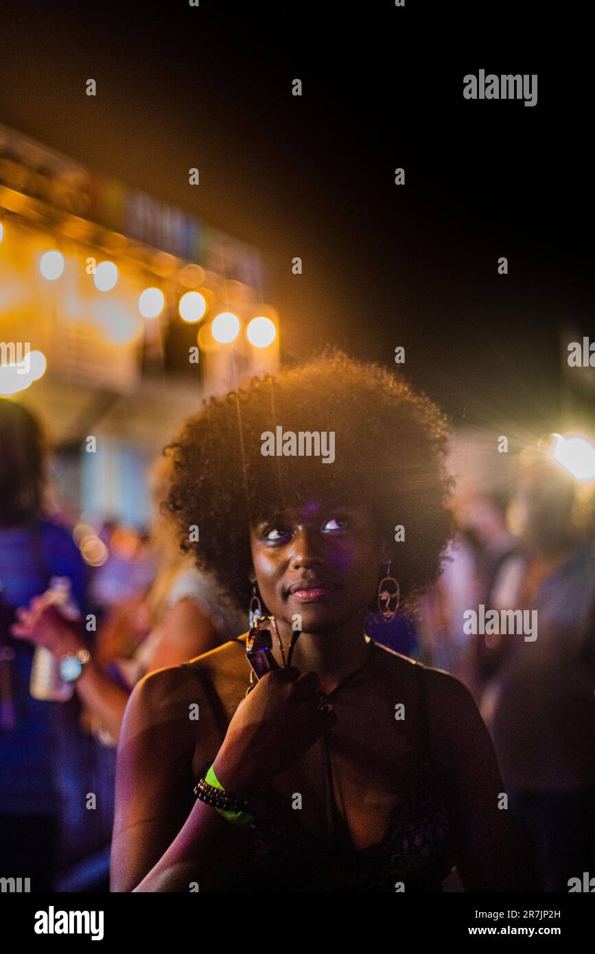 Black Gen Z female Enjoying the Music at the beach Stock Photo - Alamy