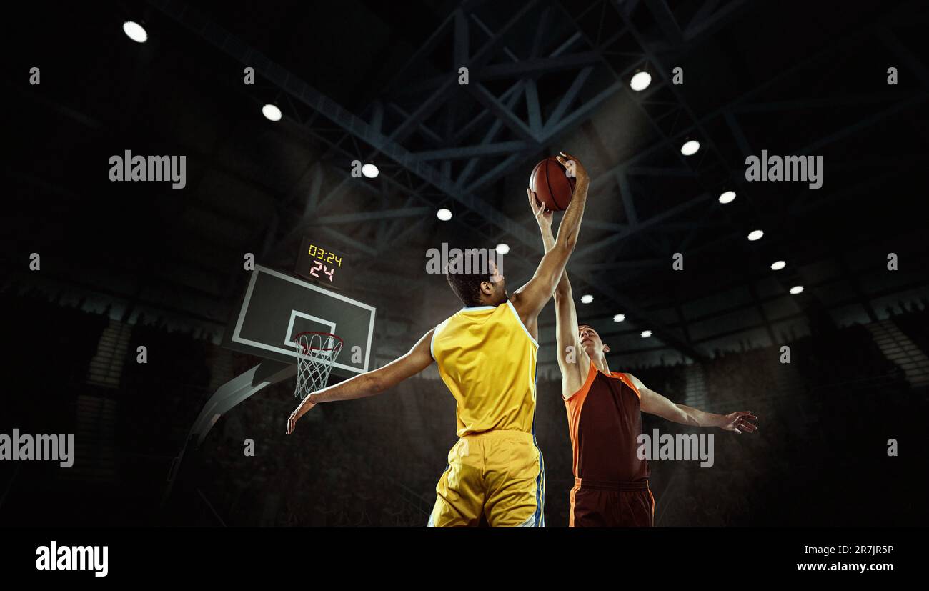 Fight for ball. Professional two basketball players in action with ...