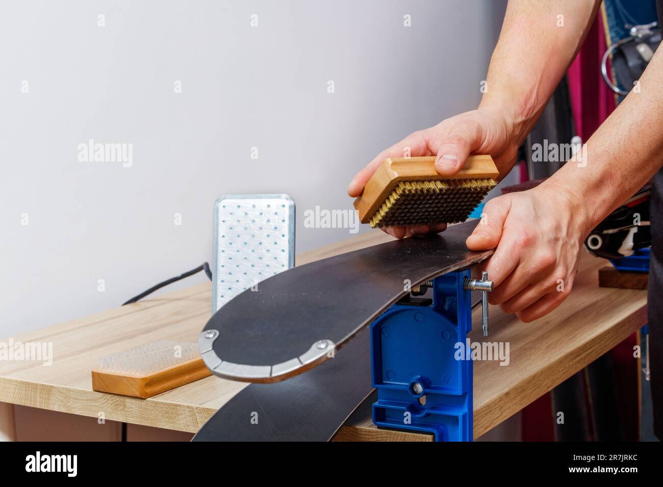 Ski secured on vises for brushing and wax treatment Stock Photo - Alamy