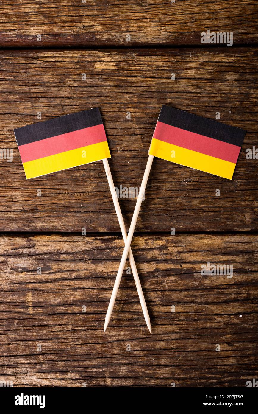 Overhead view of german national flag over wooden table, copy space ...