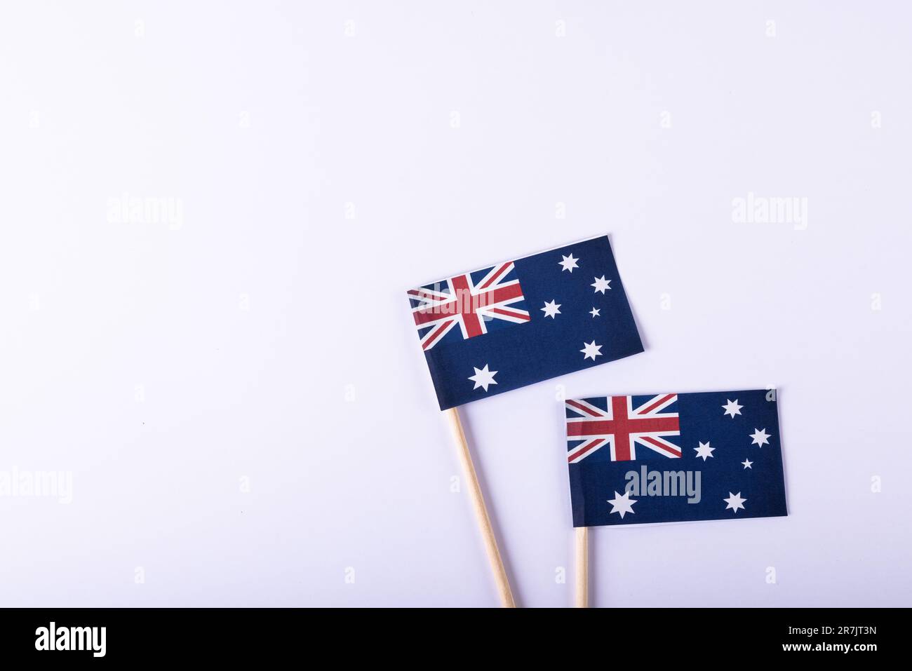 Overhead view of small australian flags over white background, copy ...
