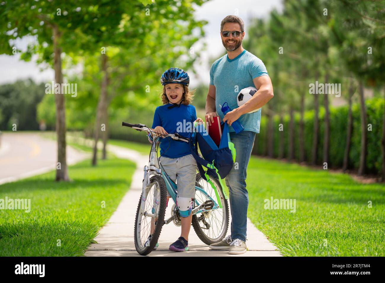 Father helping son get ready for school. Father teaching son riding ...