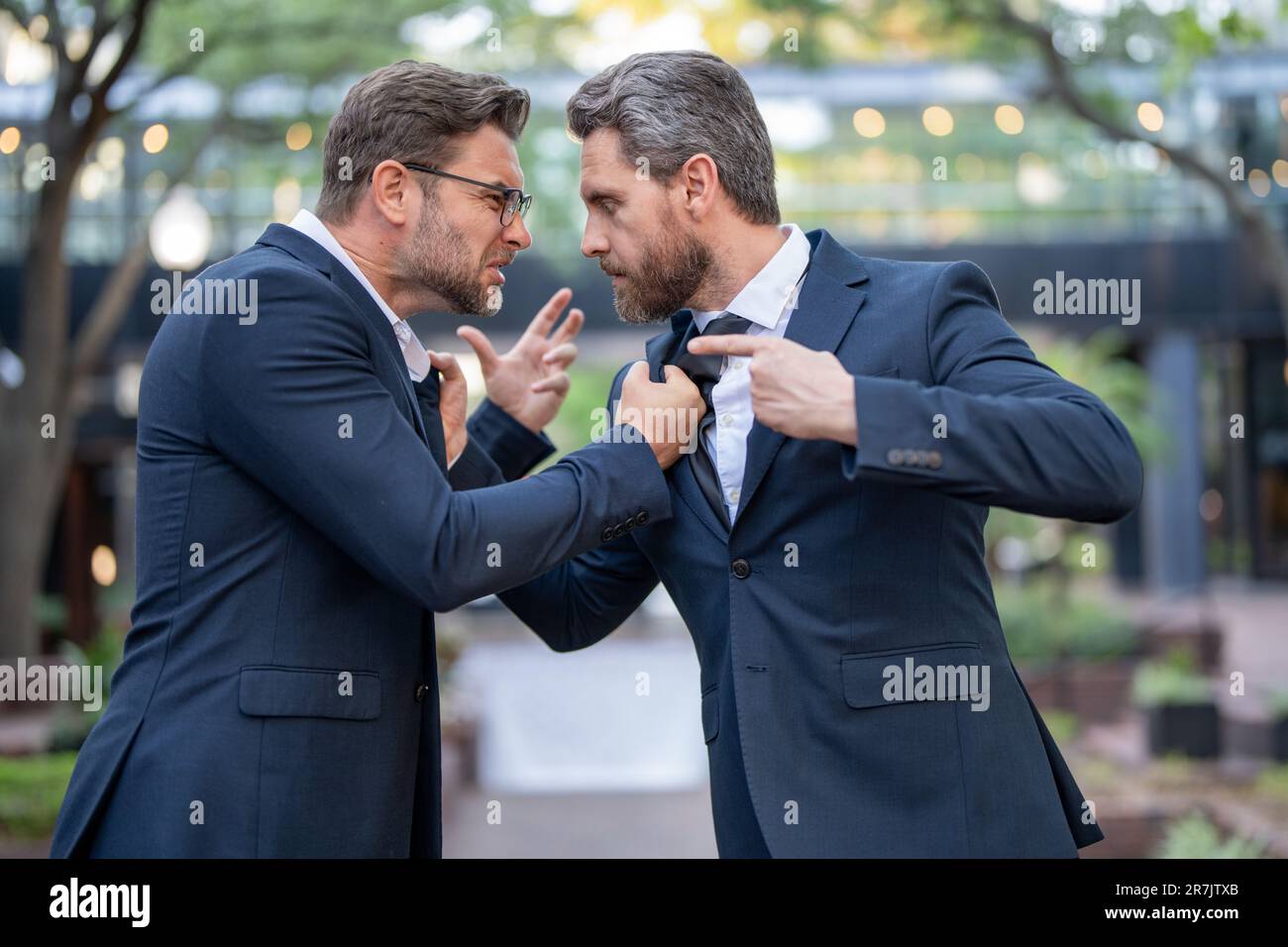 Two fighting businessmen punching. Businessmen fighting outdoor ...