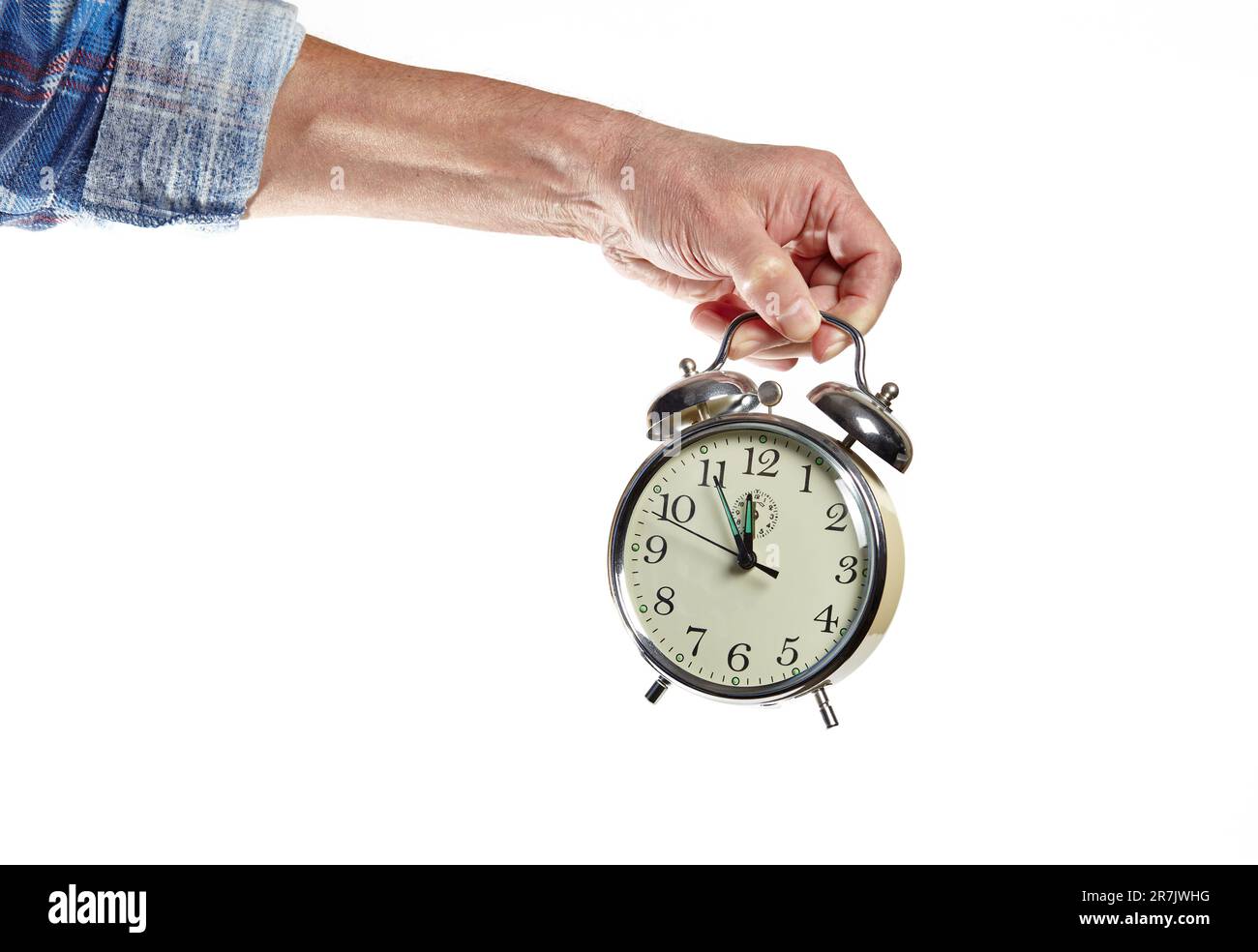 Men's hand holding alarm clock isolated on a white background. Alarm ...