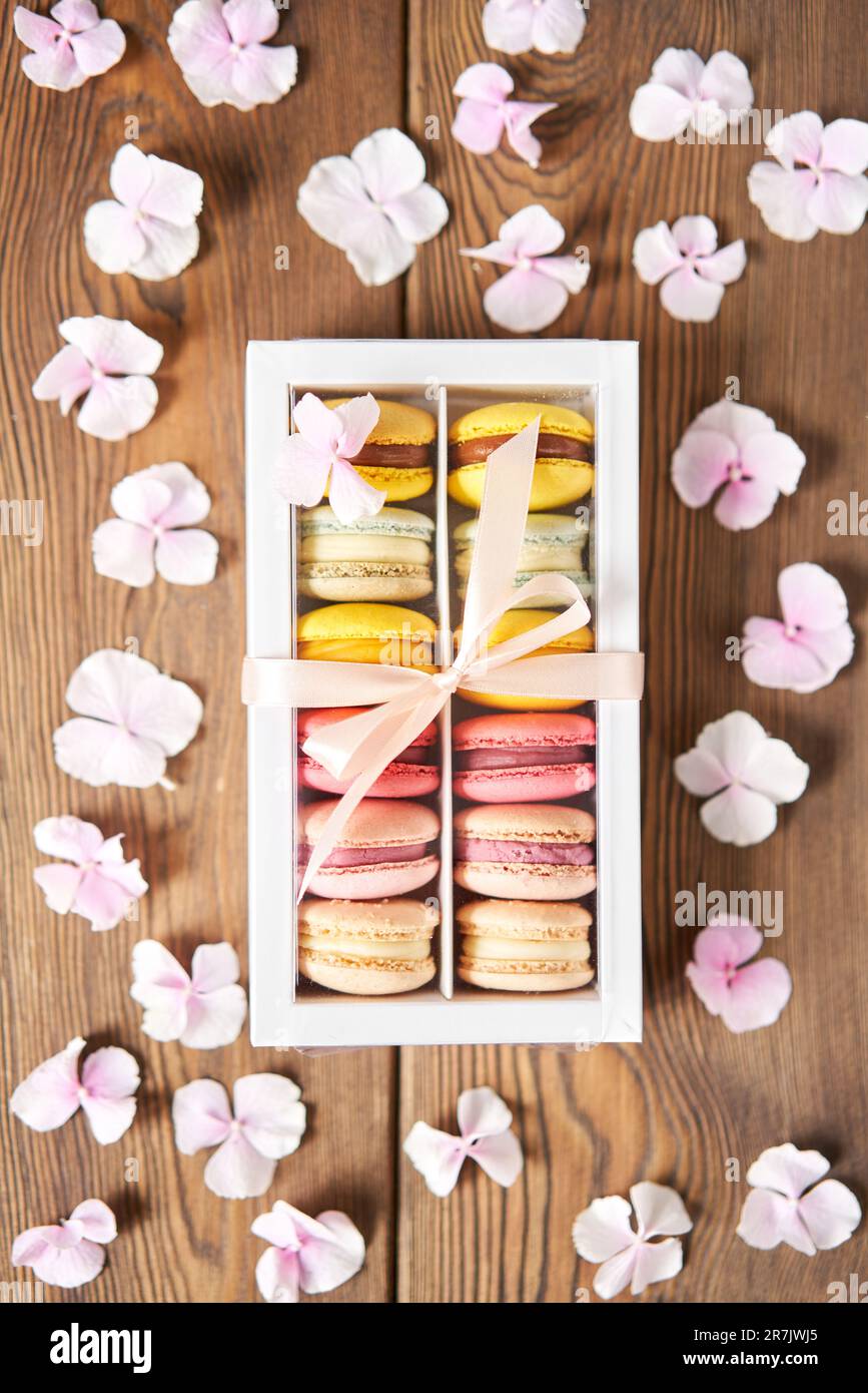 Dessert French Macarons in present box. Sweet dessert on a flowers ...