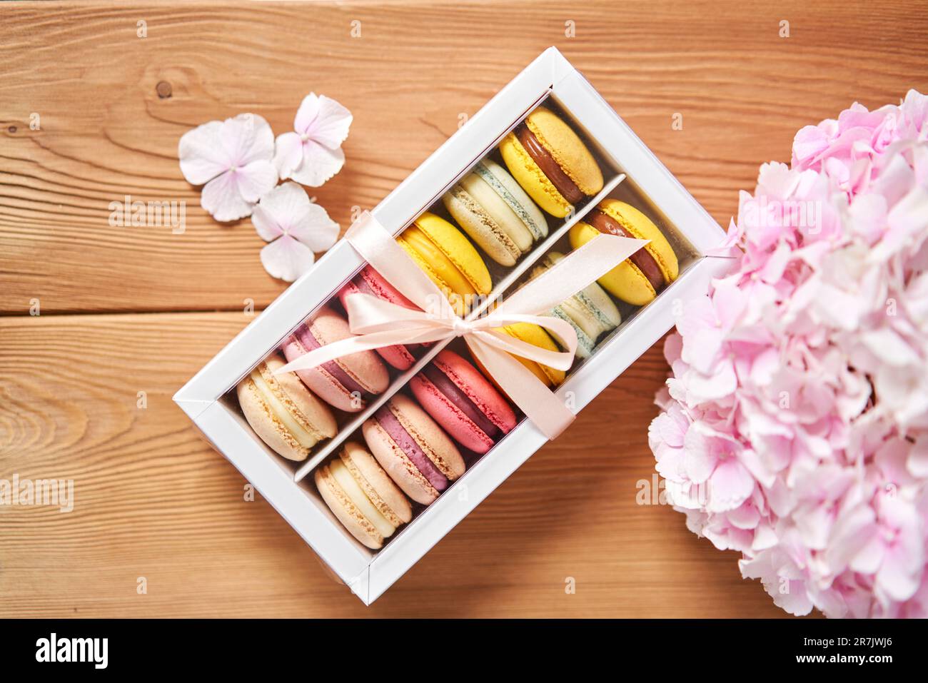Dessert French Macarons in present box. Sweet dessert on a flowers ...