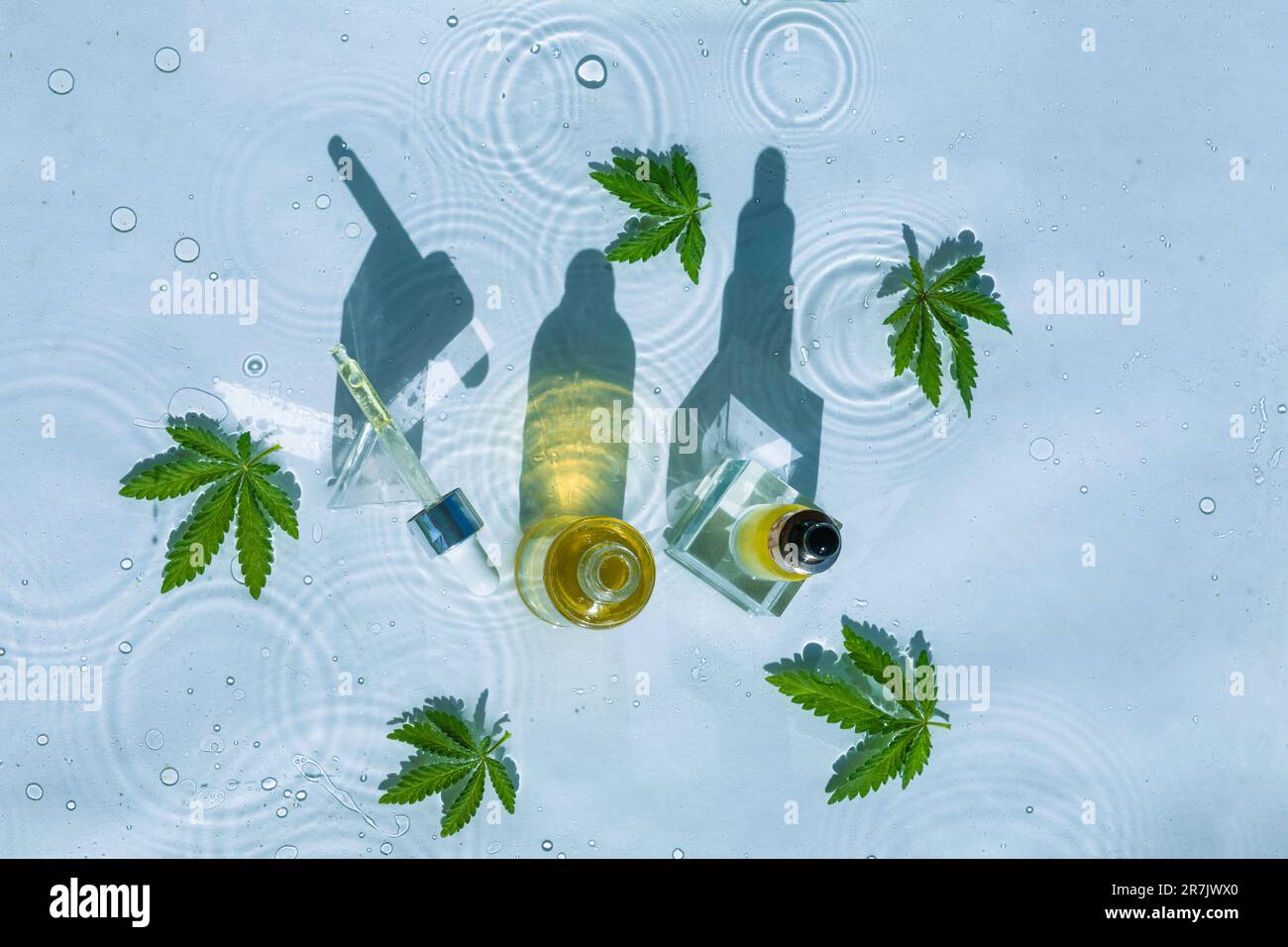 Cbd Oil Bottles, Blue water background with drops, waves and leaves of ...