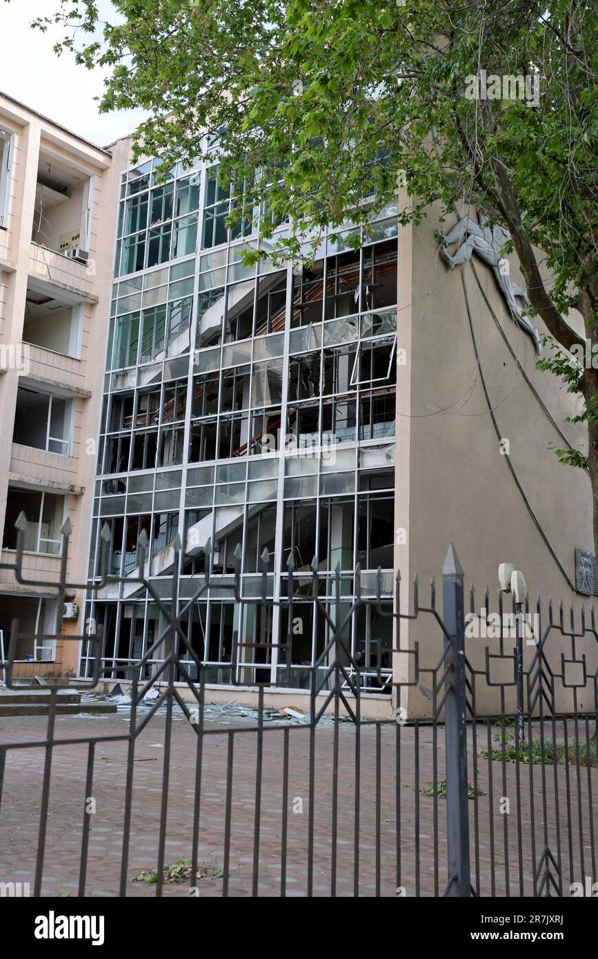 Damaged facade, broken windows of the house. War between Ukraine and ...