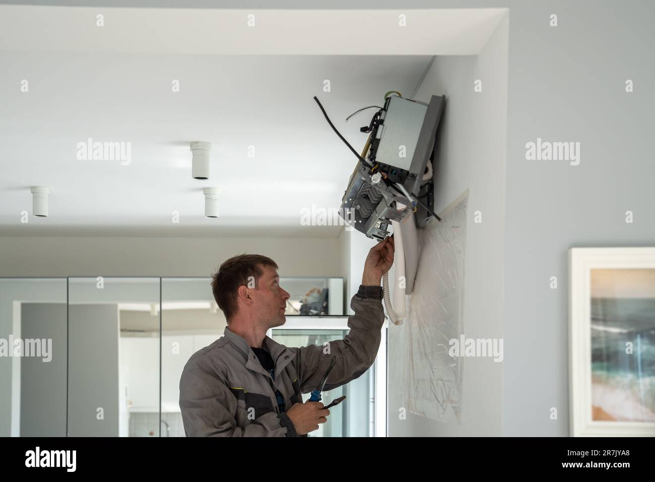 Professional man worker of climate control service in carries out ...