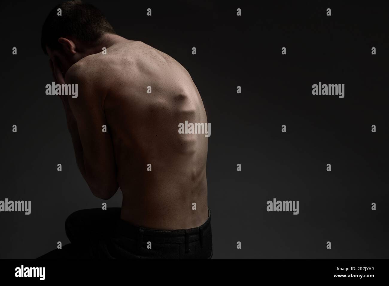 Terrifying face silhouette appearing from males skin on back, showing ...